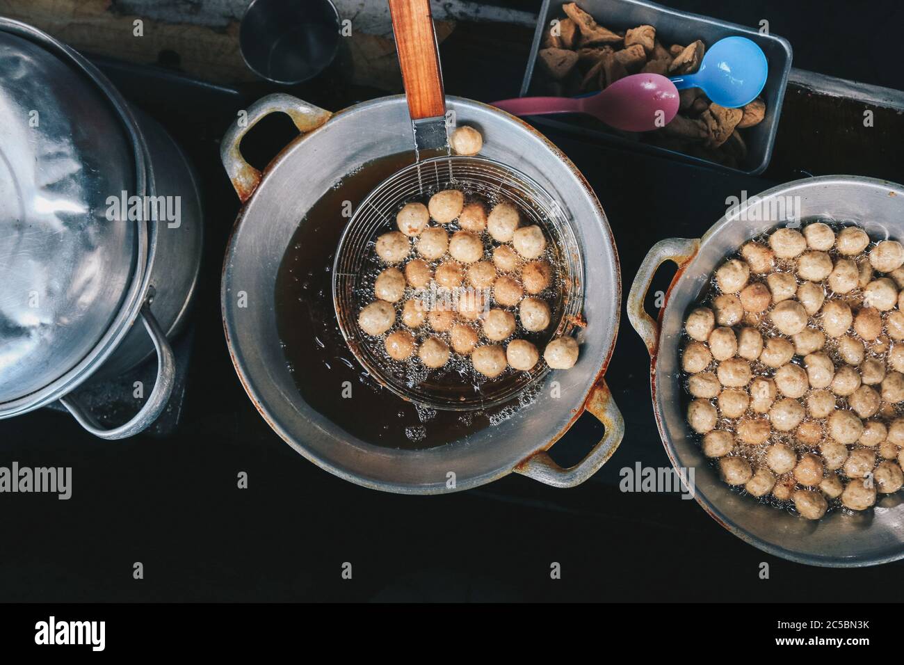 Cooking meatballs in the boiling oil in frying pan Stock Photo - Alamy