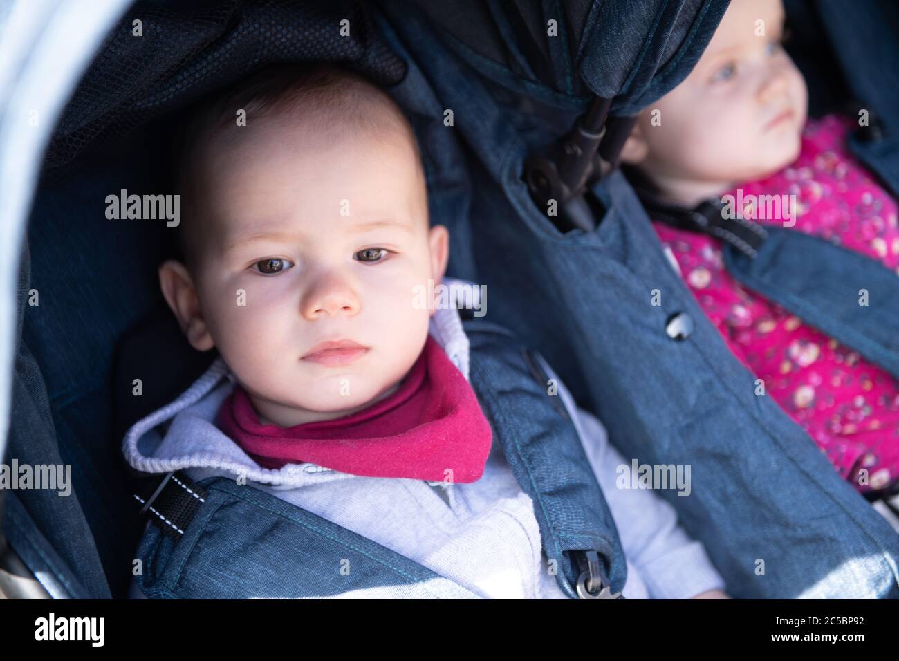 Two Baby Brother and Sister Twins Sitting in Strollers Stock Photo - Alamy