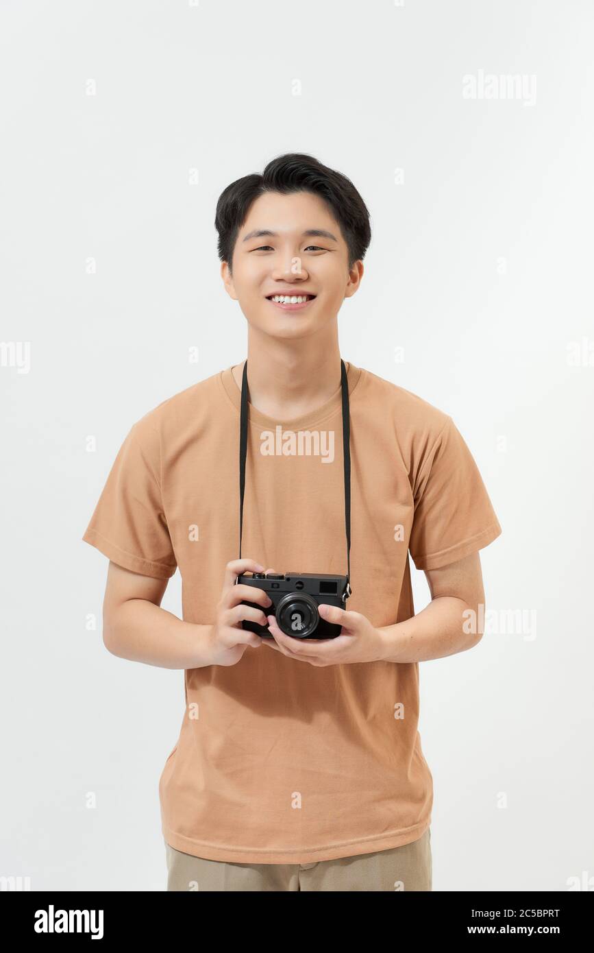 Confident photographer. Handsome young man holding digital camera and ...