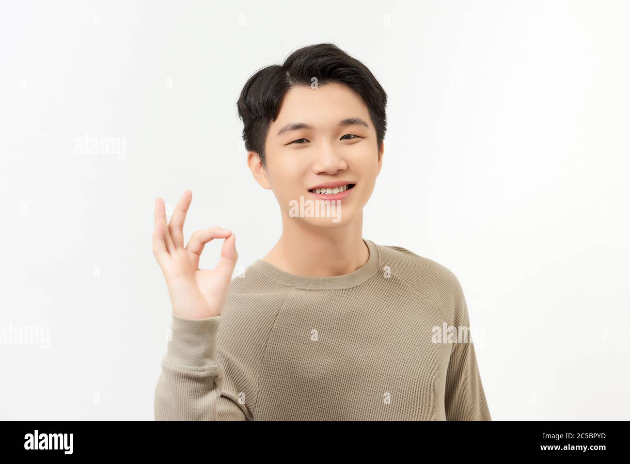 Positive handsome man shows hi-res stock photography and images - Alamy