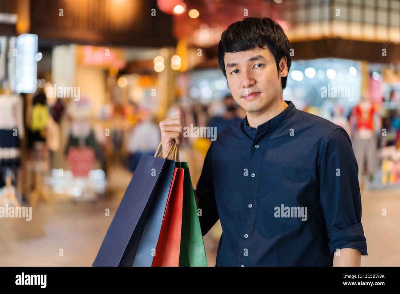 young asian man shopping with bag at mall Stock Photo - Alamy