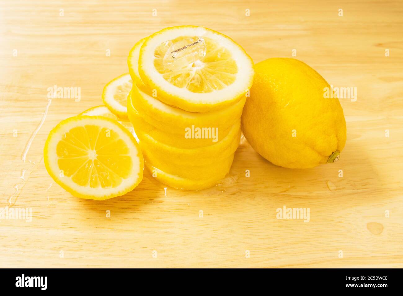 Yellow lemon Slice into pieces with ice cold Stock Photo - Alamy