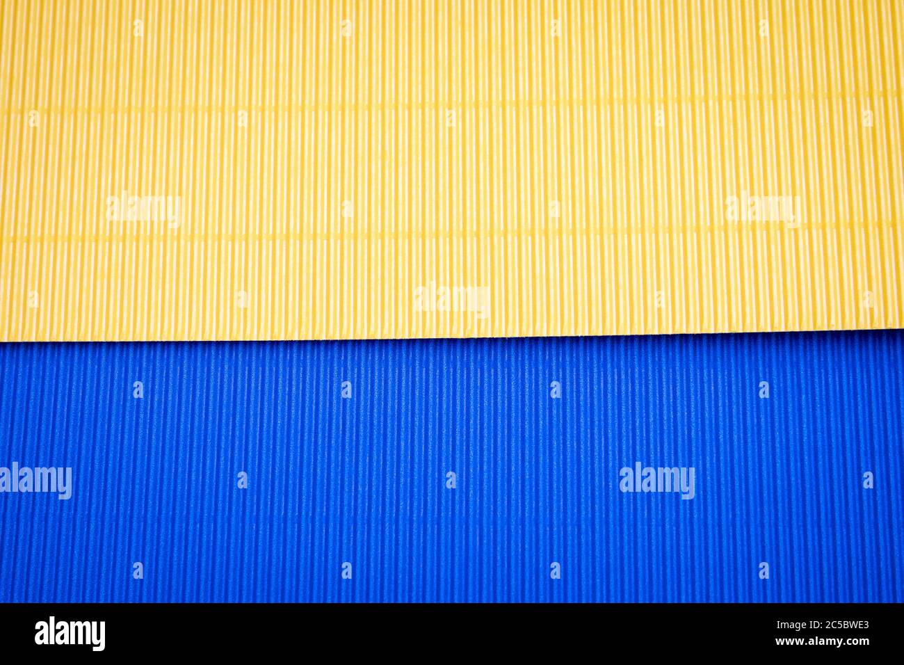 Corrugated application paper background. Yellow and blue color. Place ...