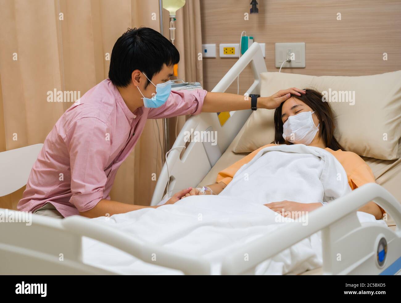 man visiting and take care female patient on a bed at hospital. people ...