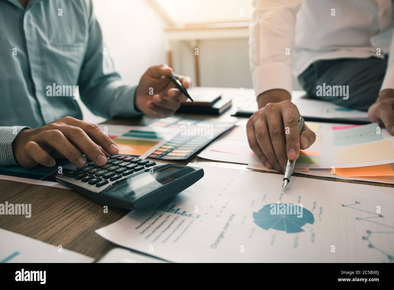 Two businessmen discussion analysis sharing calculations about the ...