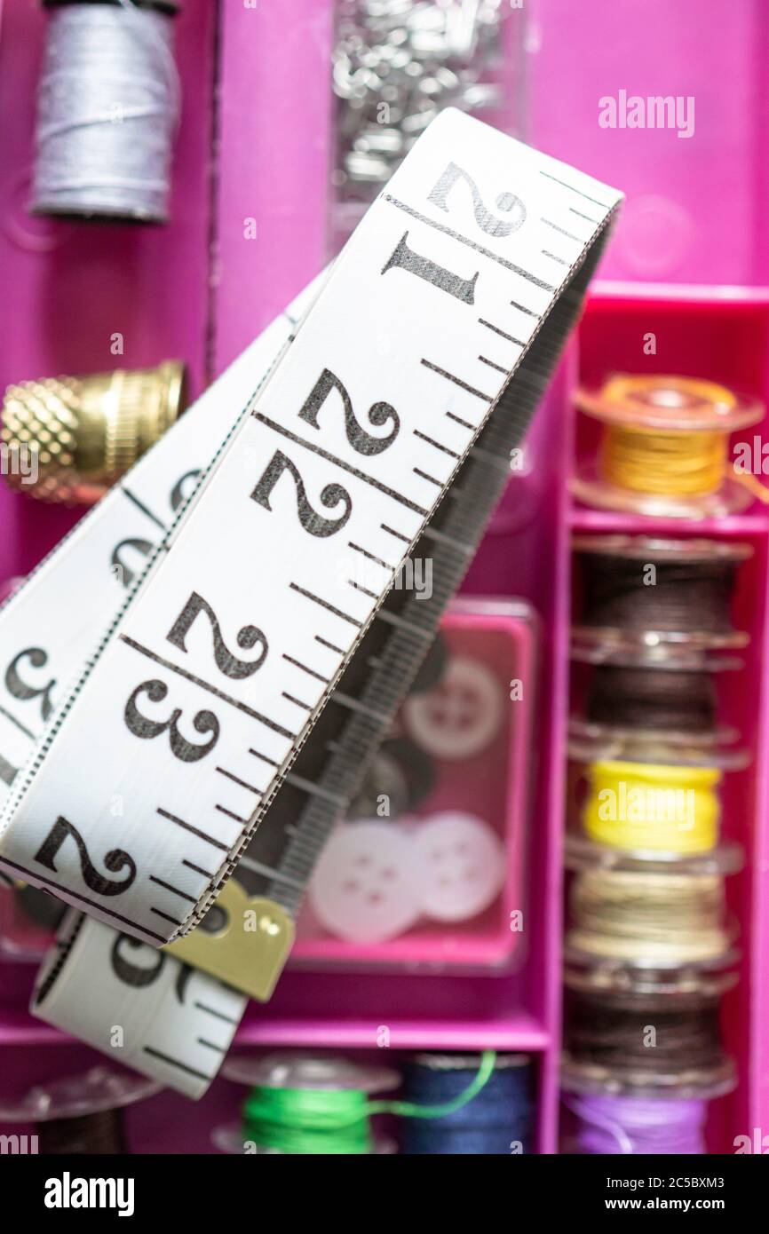 Measuring tape with collection of sewing items used by a seamstress ...