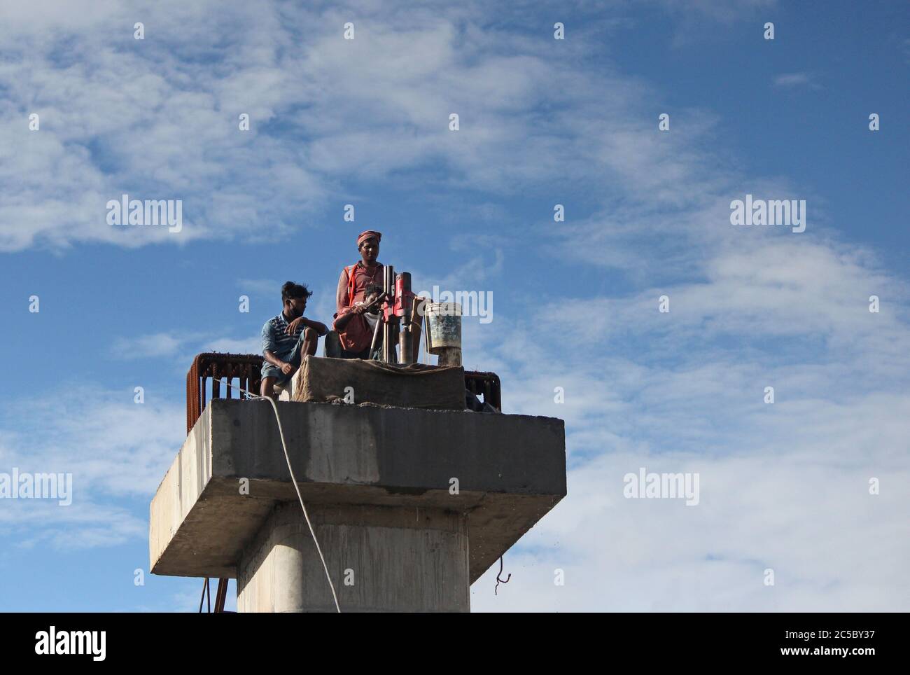 Workers working on the pillar hi-res stock photography and images - Alamy