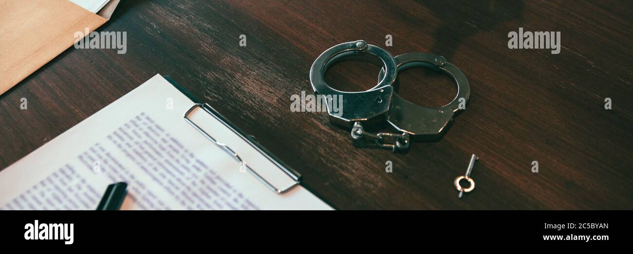 The handcuffs are placed on the desk in the investigation room Stock ...