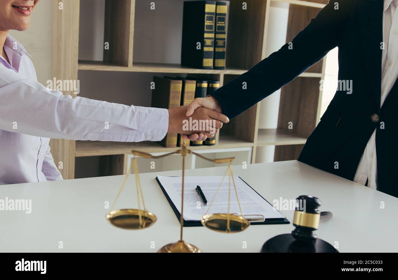 Lawyer is currently shaking hands with the client about the success in ...