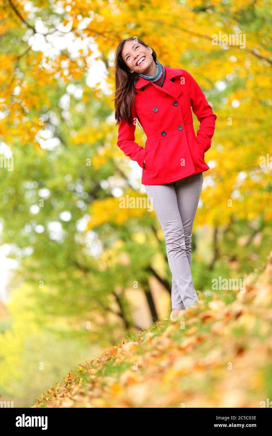 Autumn woman happy lifestyle in fall forest. Asian female model walking ...