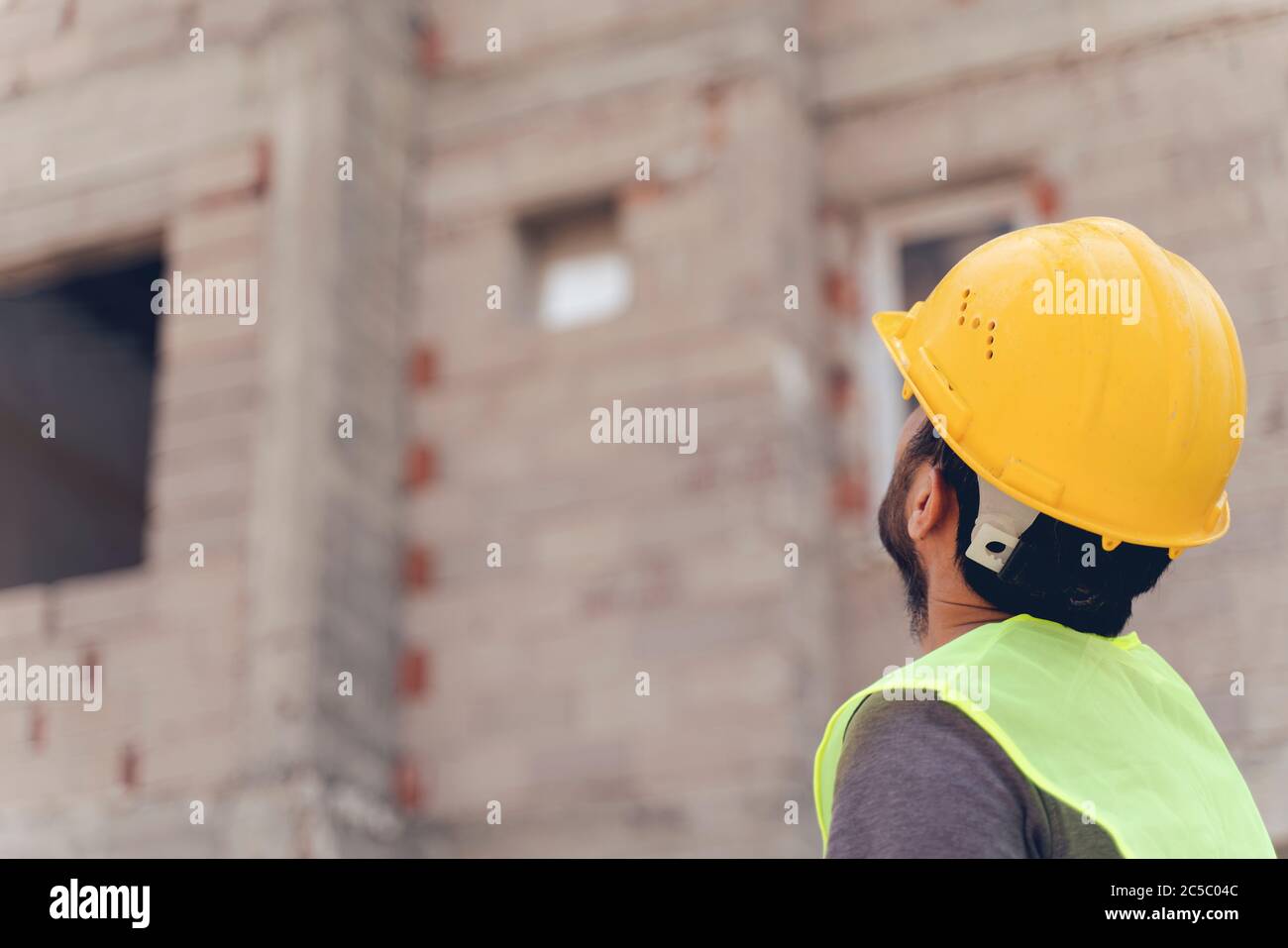 Young man architect on a building construction site Stock Photo - Alamy