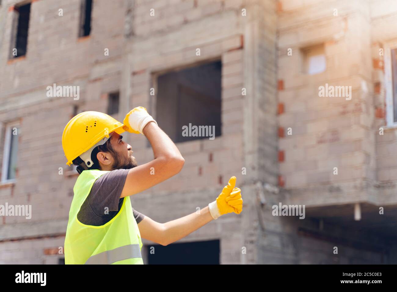 Construction engineer showing thumbs up sign at construction site Stock ...