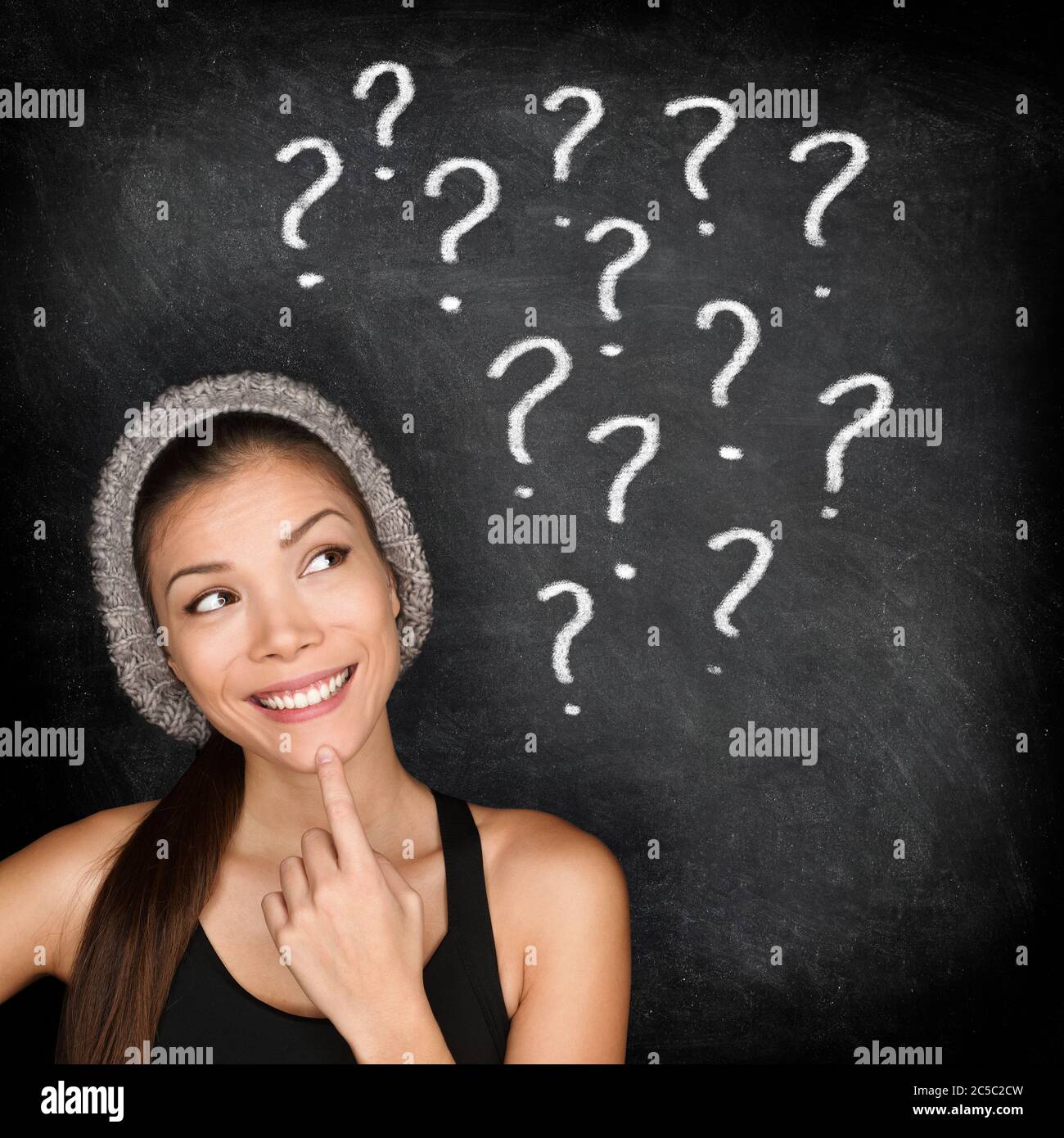 Student thinking with question marks on blackboard. Asian female young ...