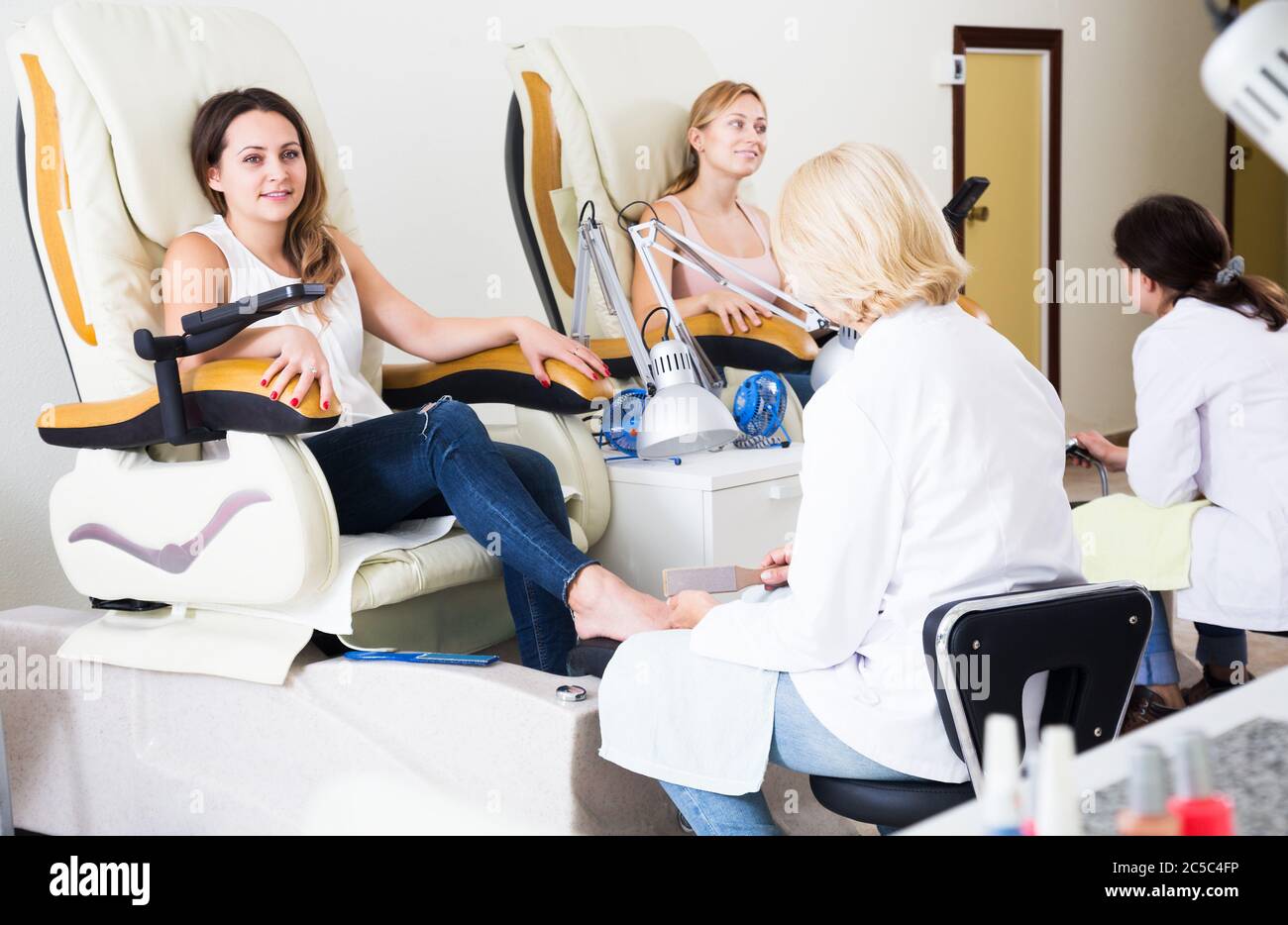 Young happy women doing pedicure in nail salon Stock Photo - Alamy