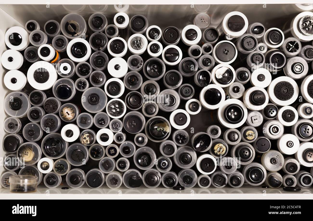 Large assortment of colored buttons of various design in tubes on ...