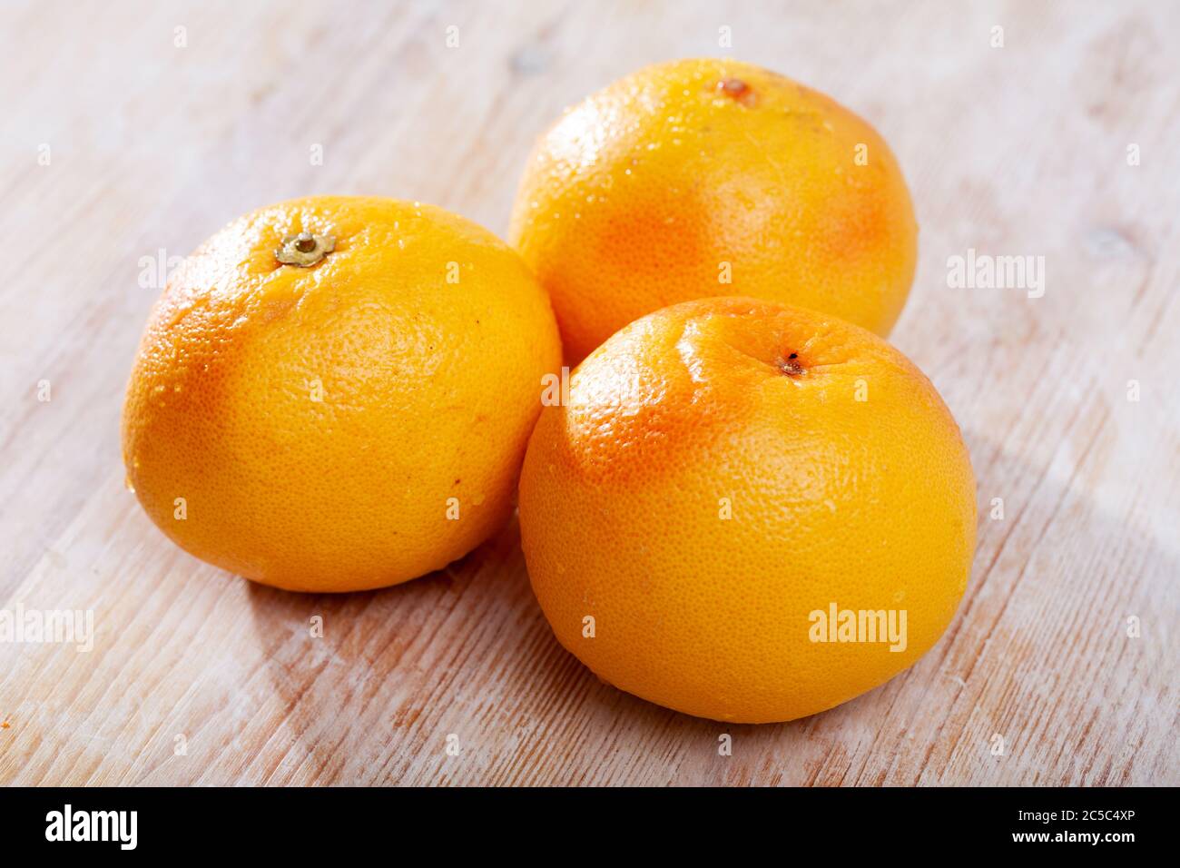 Whole and half fresh yellow pomelo on wooden table. Healthy vegetarian ...