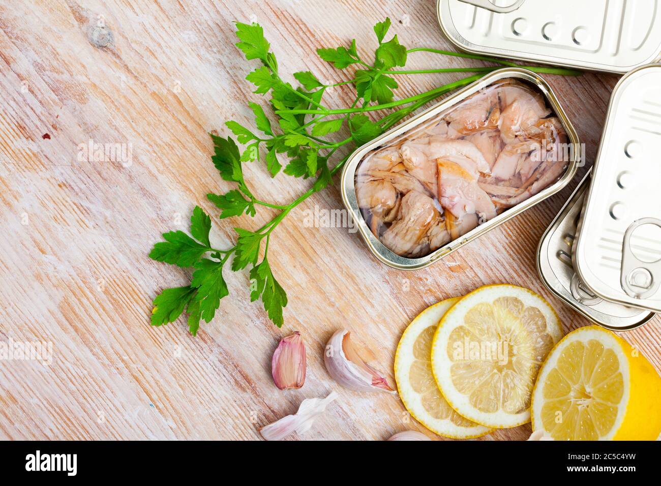 Image of canned fillet of tuna in open tin can on wooden desk with ...