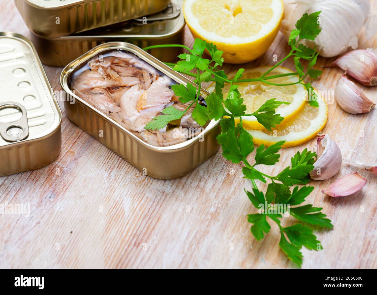 Image of canned fillet of tuna in open tin can on wooden desk with ...