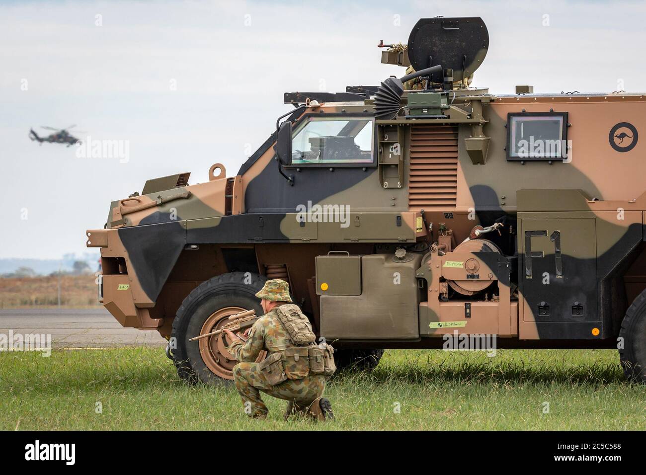 Australian Army soldier with a Bushmaster armored personnel carrier ...