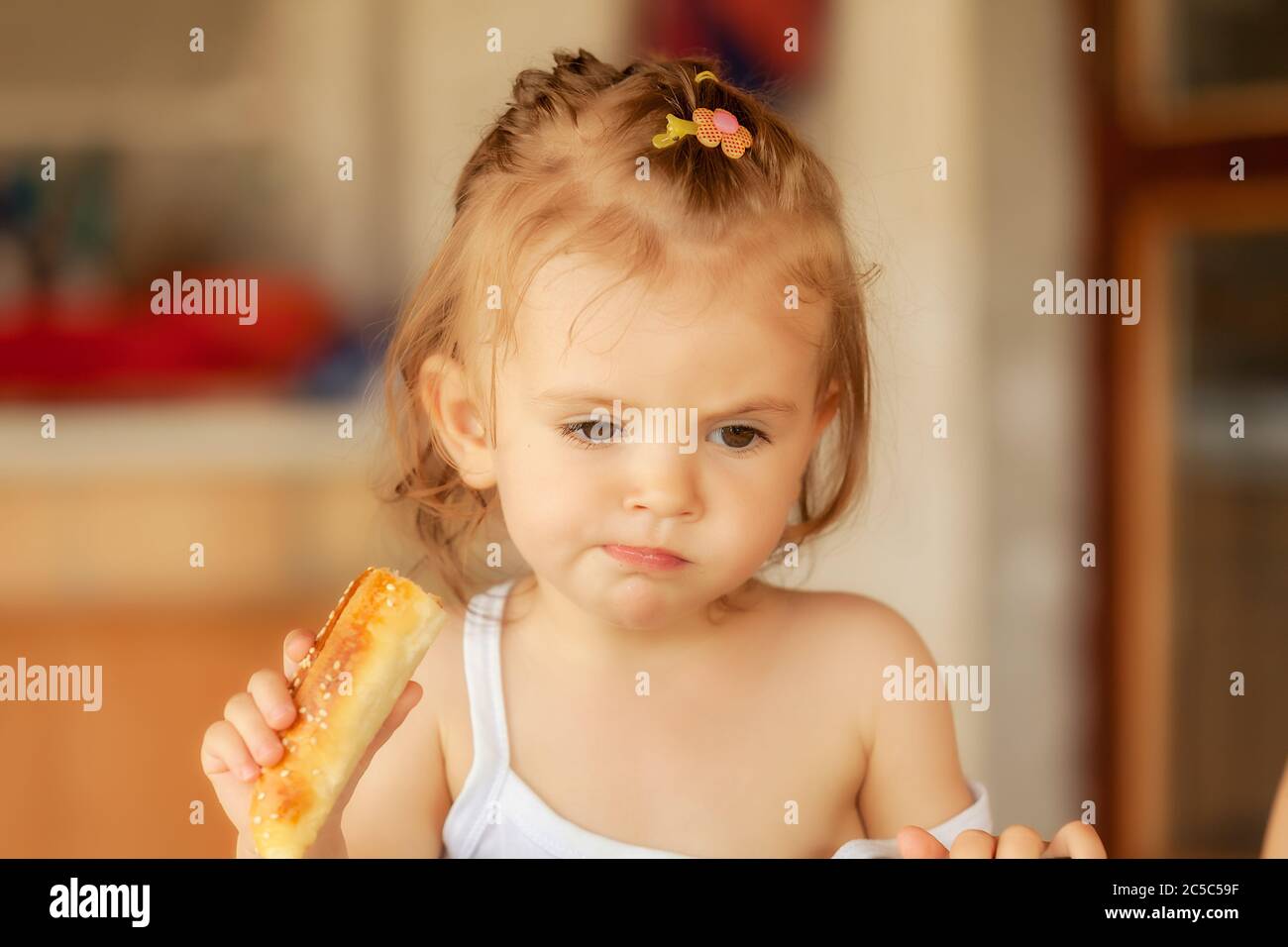 child eating pastry with sesame, note shallow depth of field Stock ...