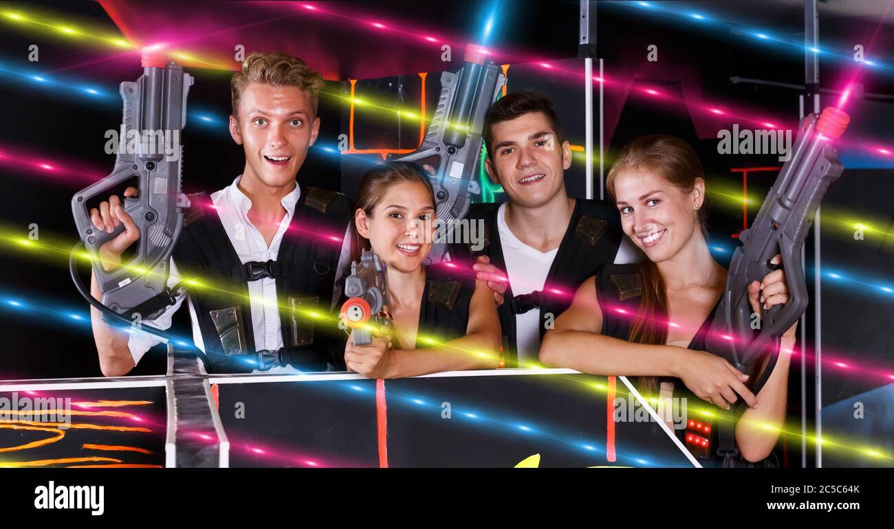 Group portrait of command players with pistols in their hands in dark ...