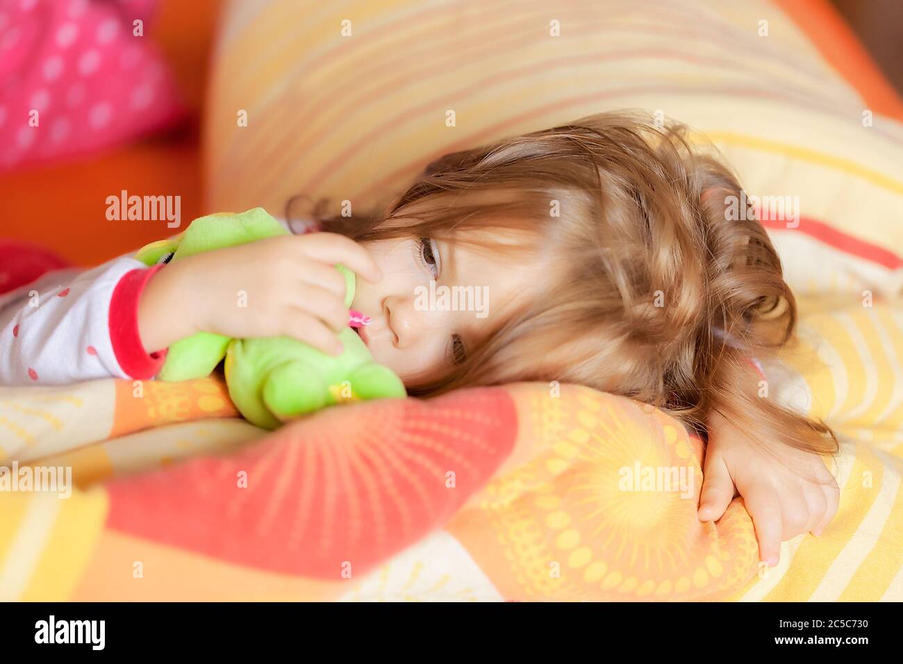 child are preparing for sleep with toy in the hand, note shallow dept ...