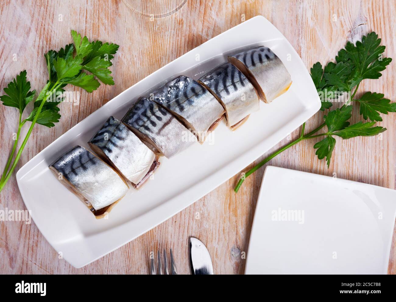 Image of slices of lightly salted mackerel fish served with greens ...