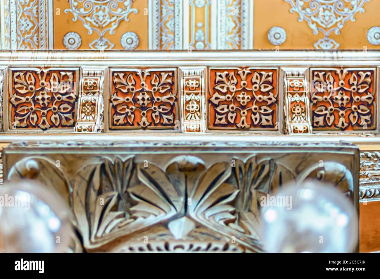 Intricate stucco work and ornate carvings on the ceiling and the ...