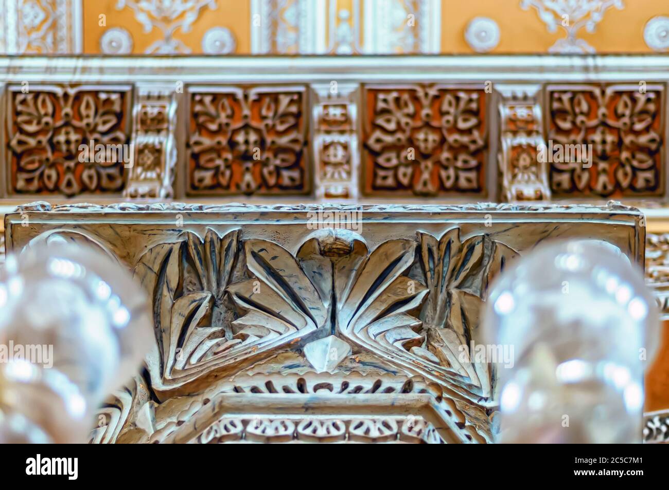 Intricate stucco work and ornate carvings on the ceiling and the ...