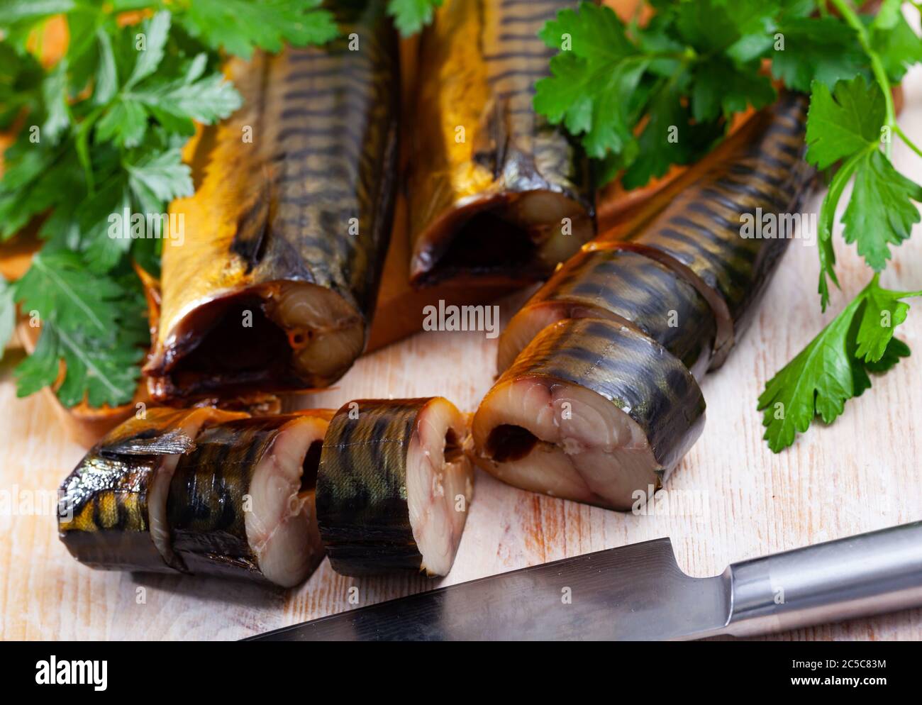 Pieces of delicious smoked scomber with fresh parsley. Fish appetizer ...