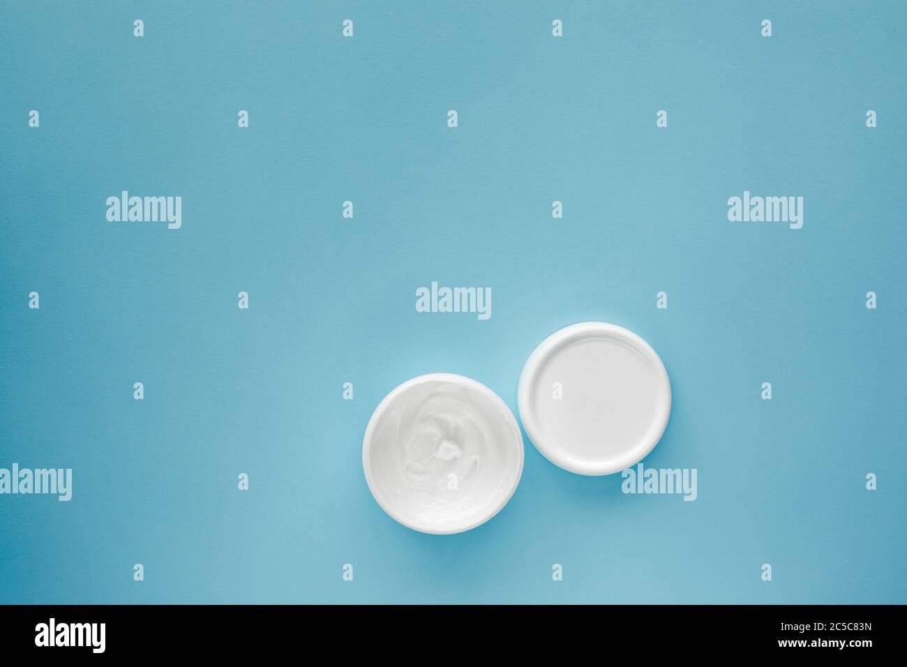 open blank cosmetics jar on blue background. moisturizing cream jar ...