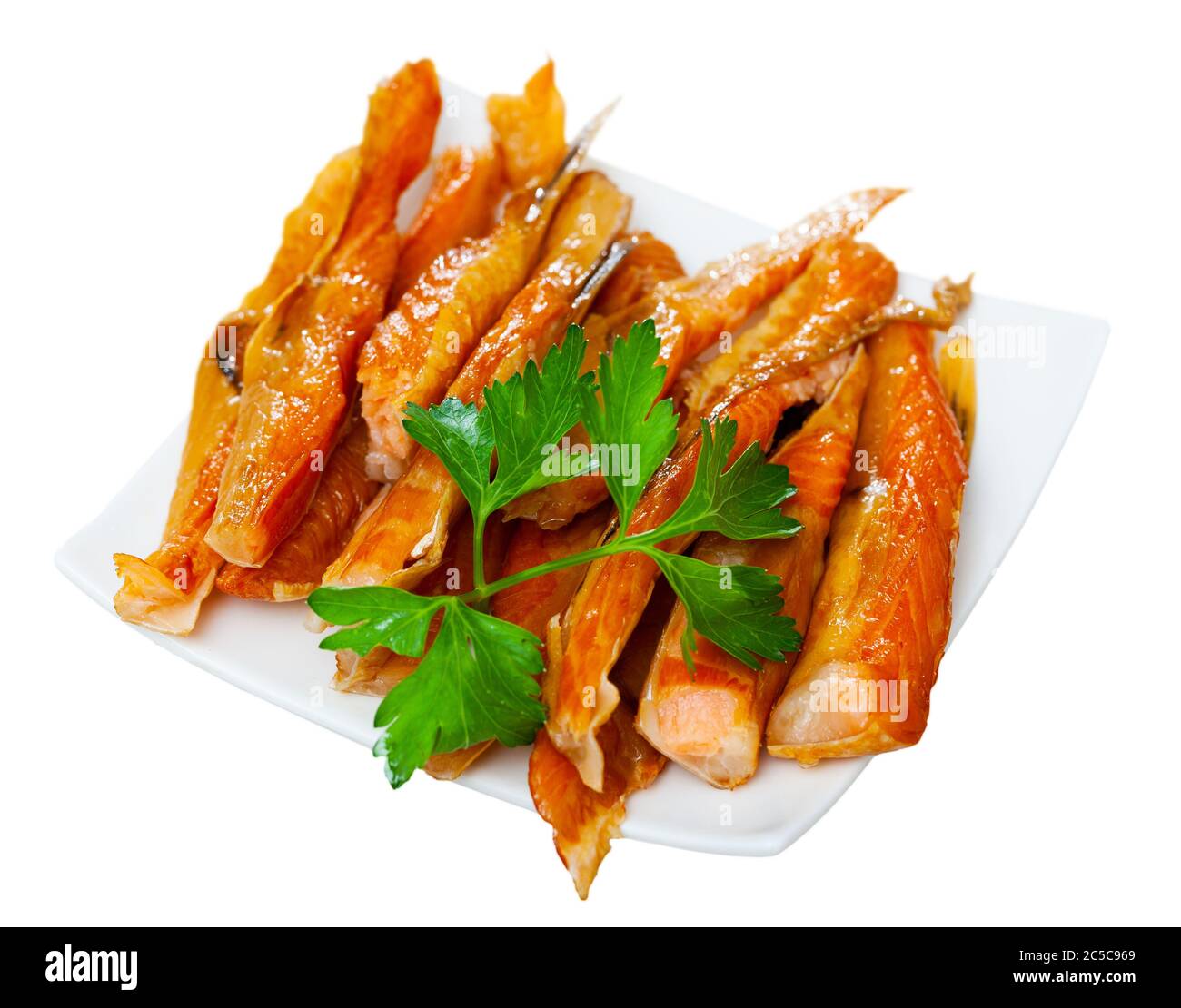Strips of cold-smoked red fish on plate. Isolated over white background ...