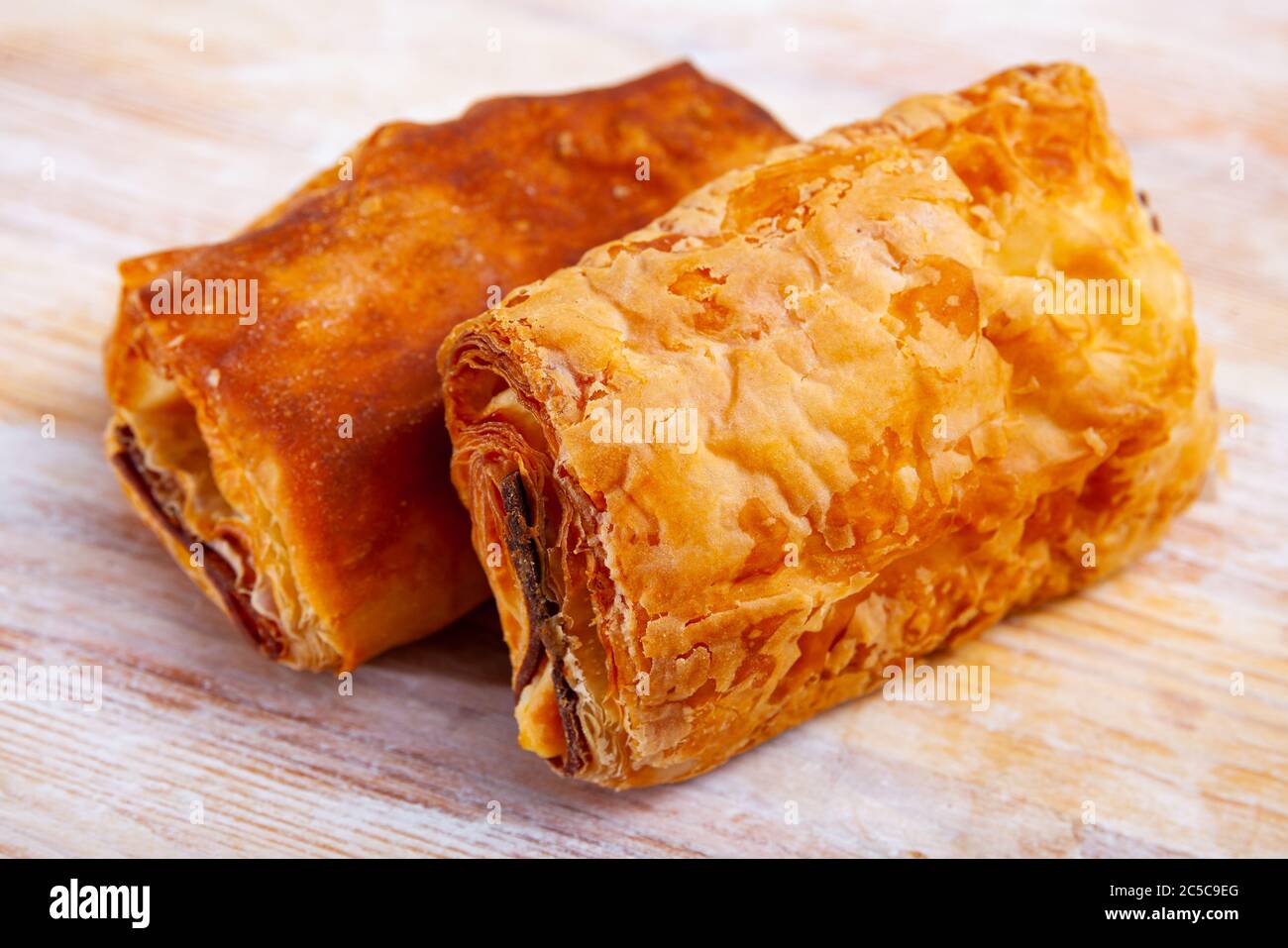 Puff pastry roll filled with meat and cheese, spanish Napolitana Stock ...