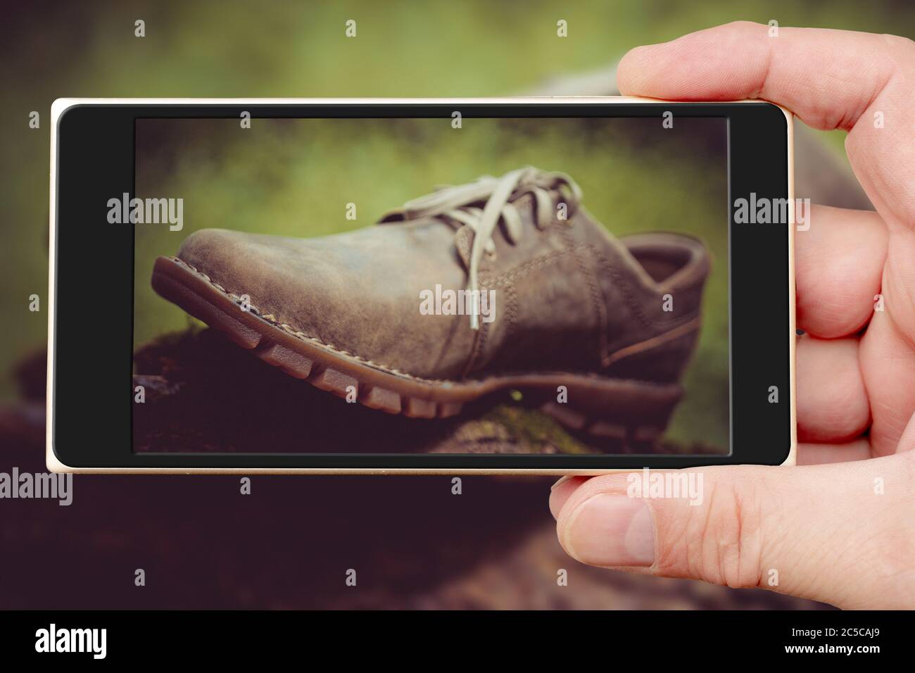 Shoes on smartphone screen. New stylish brown mens shoes Stock Photo ...