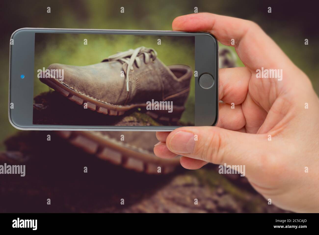 Shoes on the smartphone screen. New stylish brown men's shoes Stock ...