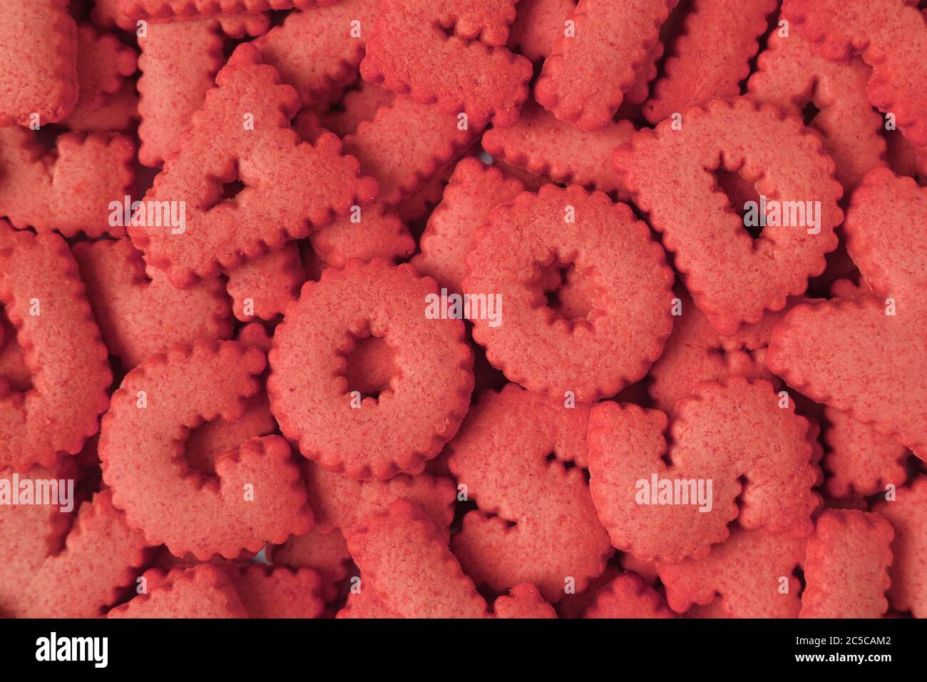 Top view of red colored alphabet shaped cookies spelling the word GOOD ...