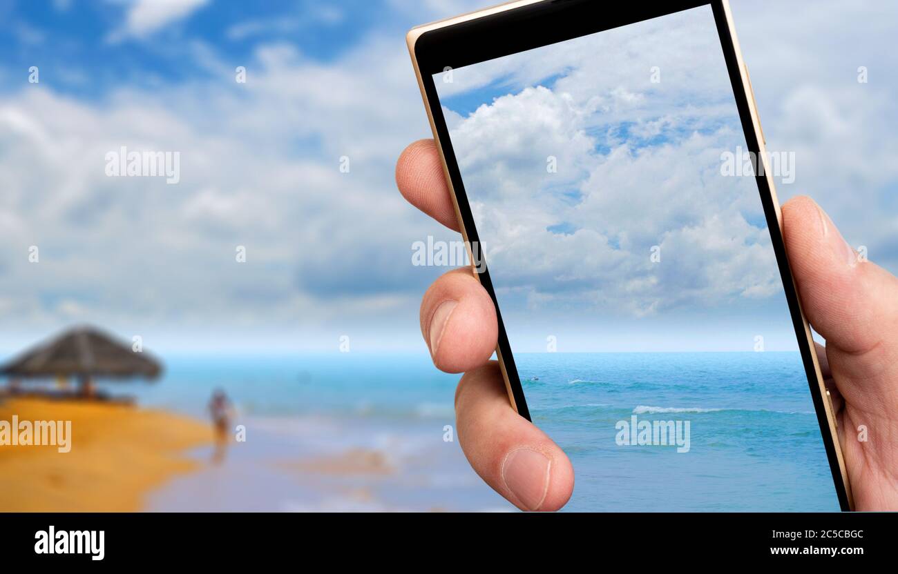 Sandy ocean beach on smartphone screen. Sunny day in tropics Stock ...