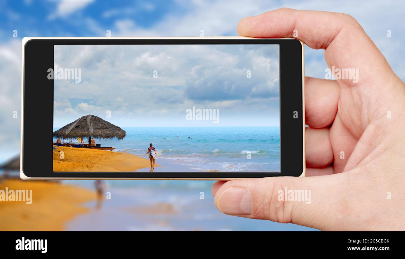 Sandy ocean beach on smartphone screen. Sunny day in tropics Stock ...
