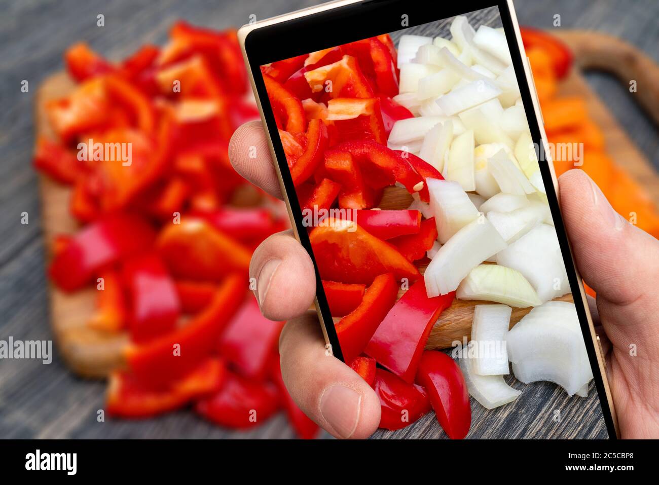 Sliced vegetables on smartphone screen. Cooking in kitchen Stock Photo ...