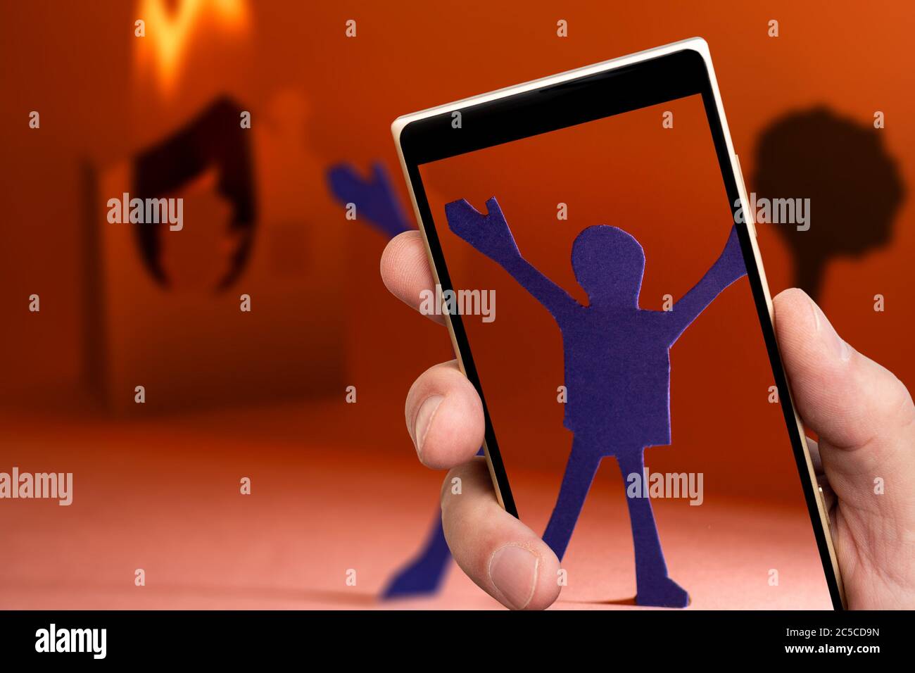 Man on screen of smartphone. Fire and man with hands up Stock Photo - Alamy