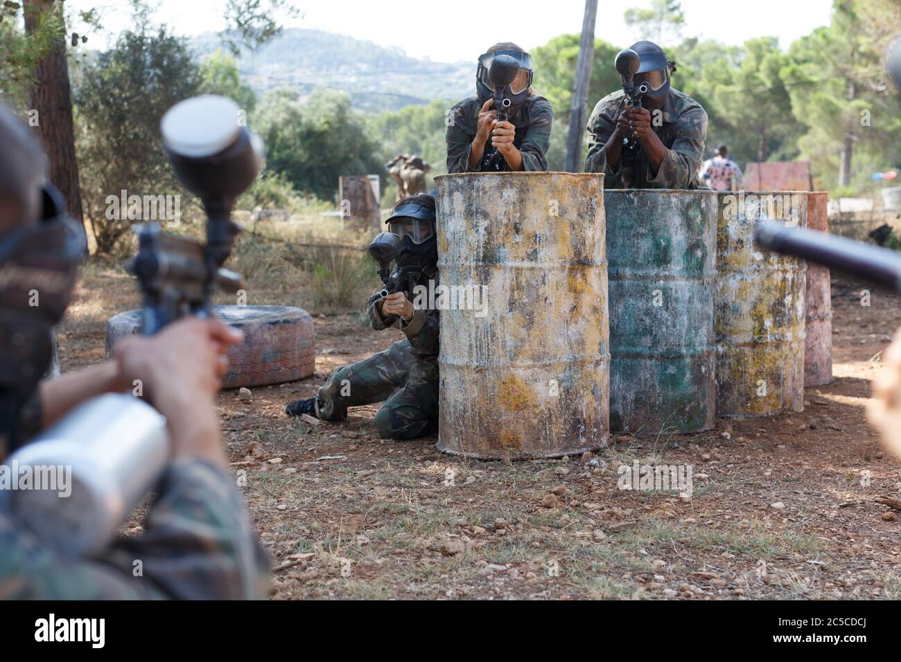 Teams facing on battlefield in outdoor paintball arena Stock Photo - Alamy