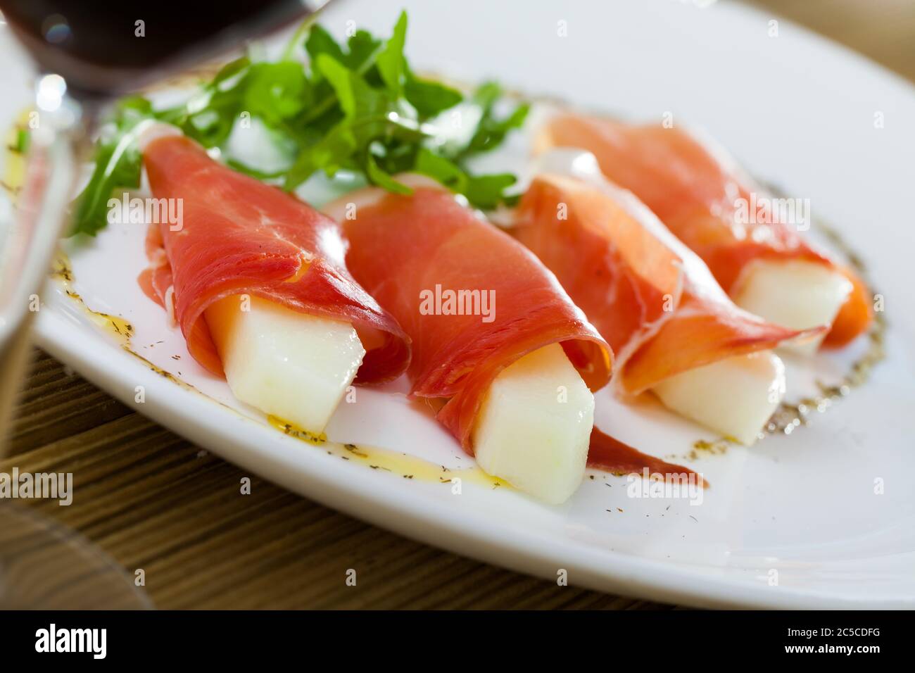 Thin slices of jamon served with melon and arugula – national Spanish ...
