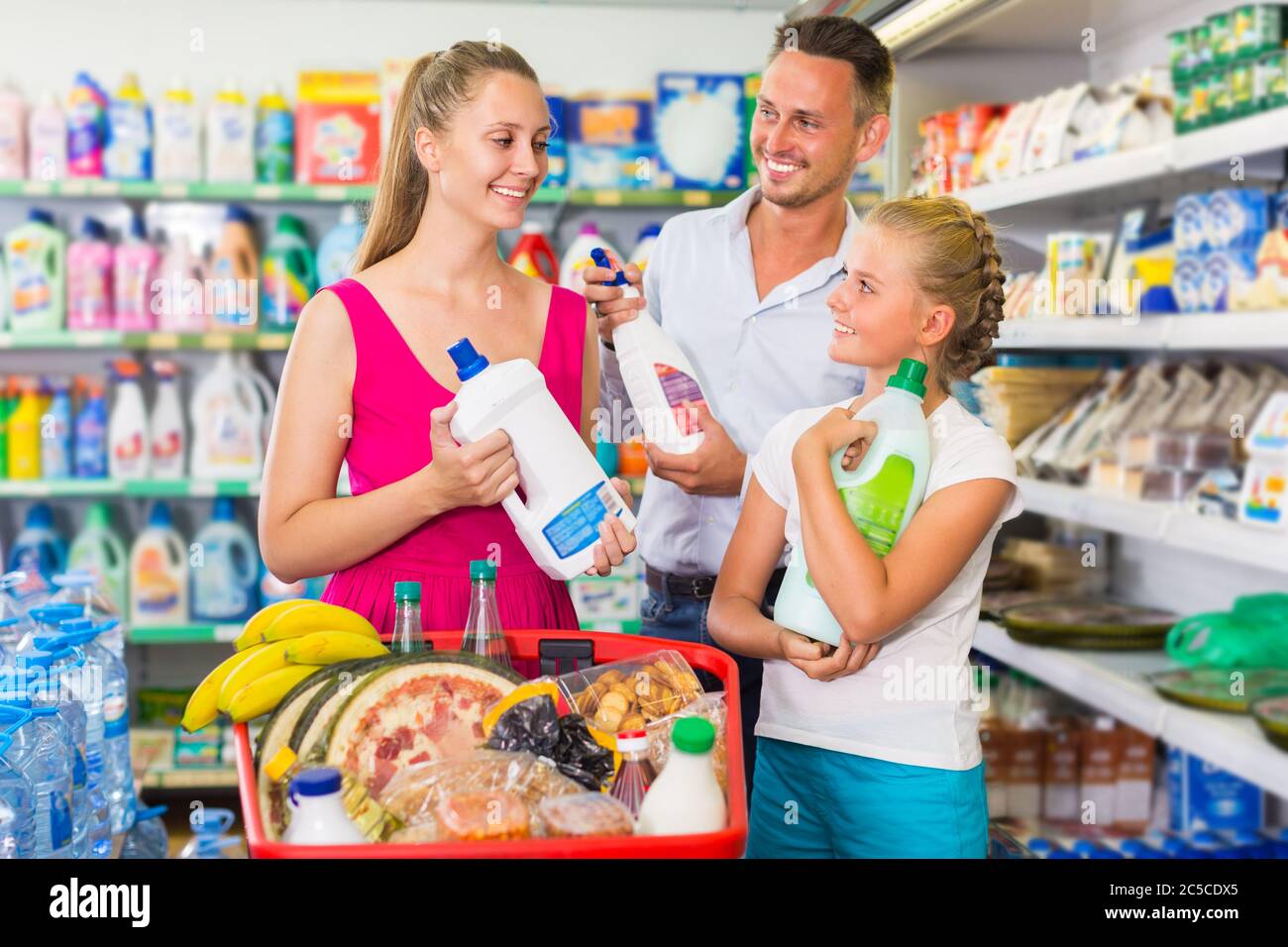 Family of three are selecting detergents in housekeeping store Stock ...