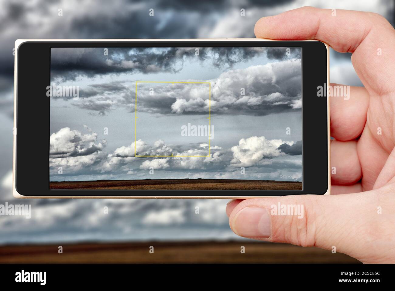 Gloomy clouds on smartphone screen. Autumn cloudy day. Landscape with ...