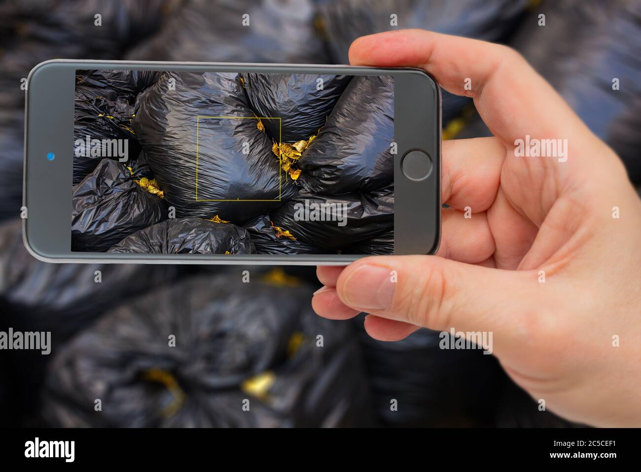 Garbage bags in smartphone screen. Garbage collection. Black bags of ...