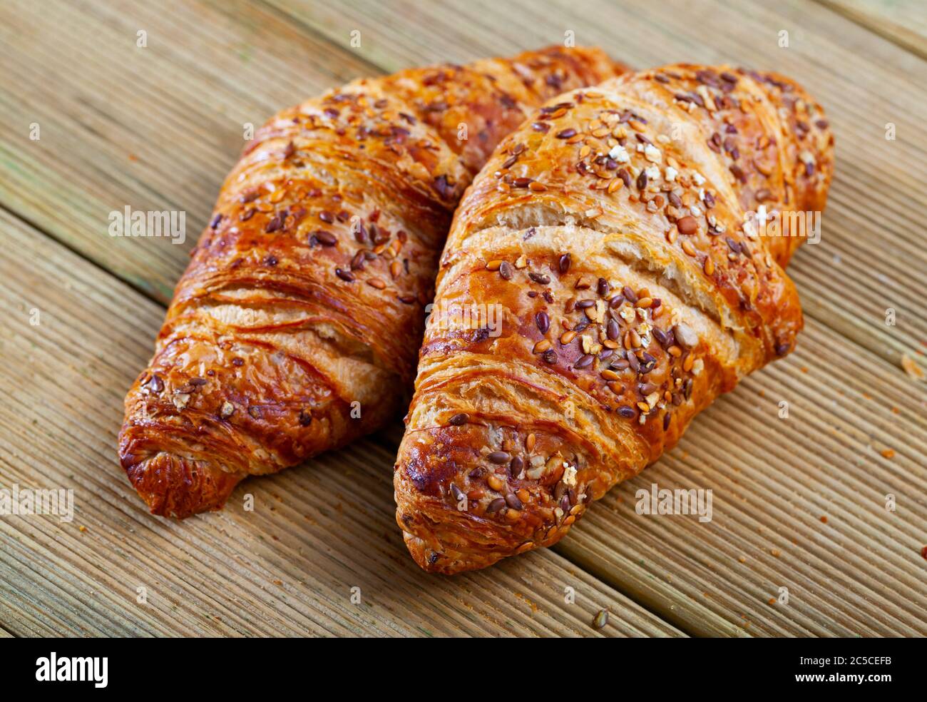 Sesame seed croissants, french dessert at wooden surface Stock Photo ...