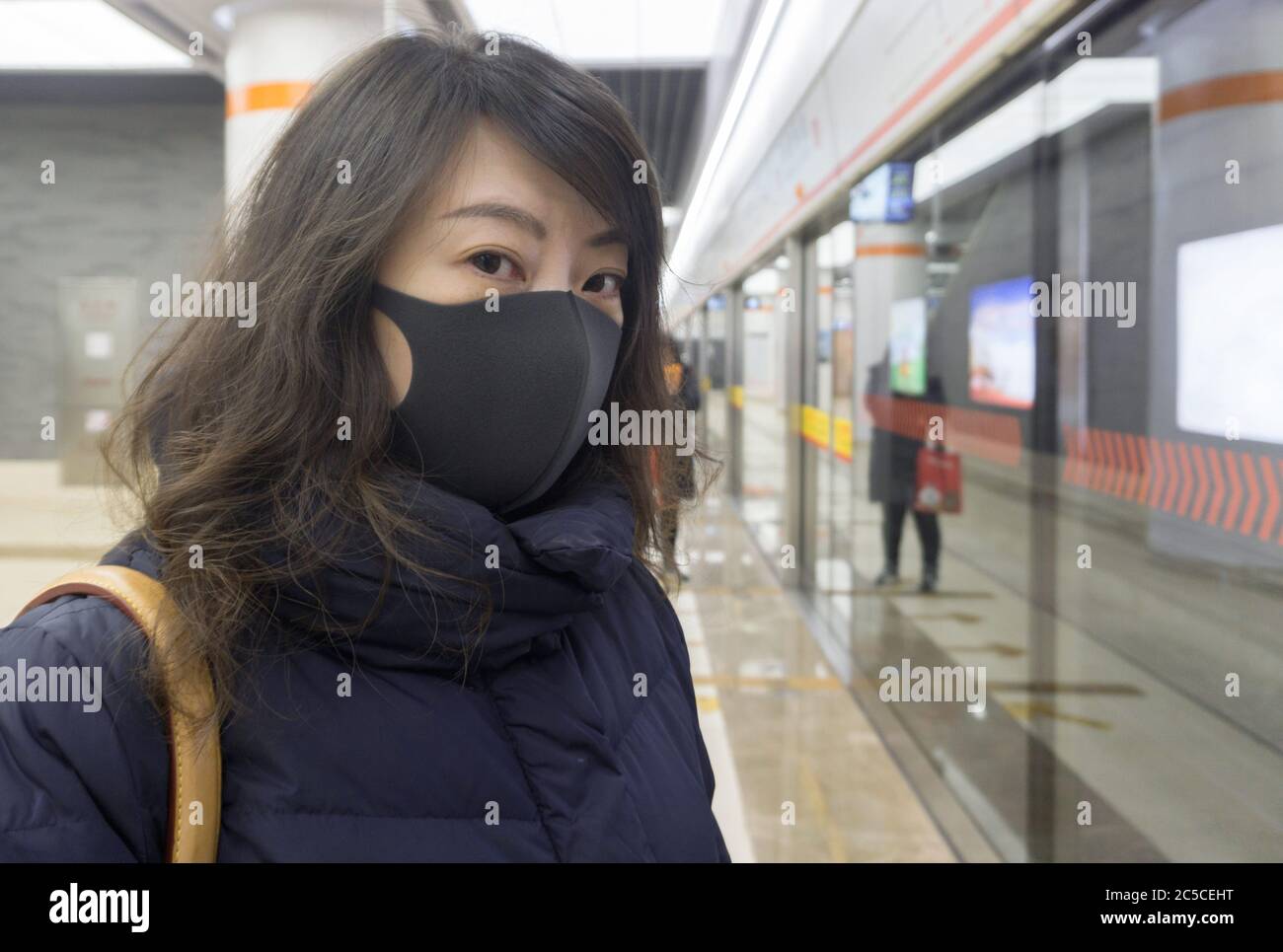 Asian young woman wearing a hygiene protective mask over her face at ...