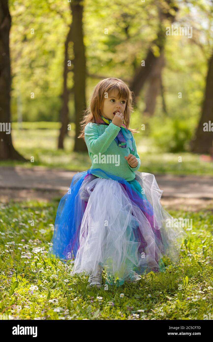 the girl poses next to the tree Stock Photo - Alamy