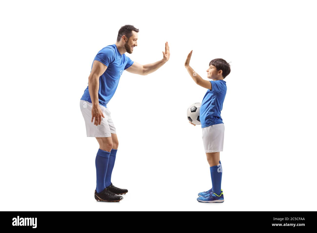 Full length profile shot of an adult football player gesturing high ...