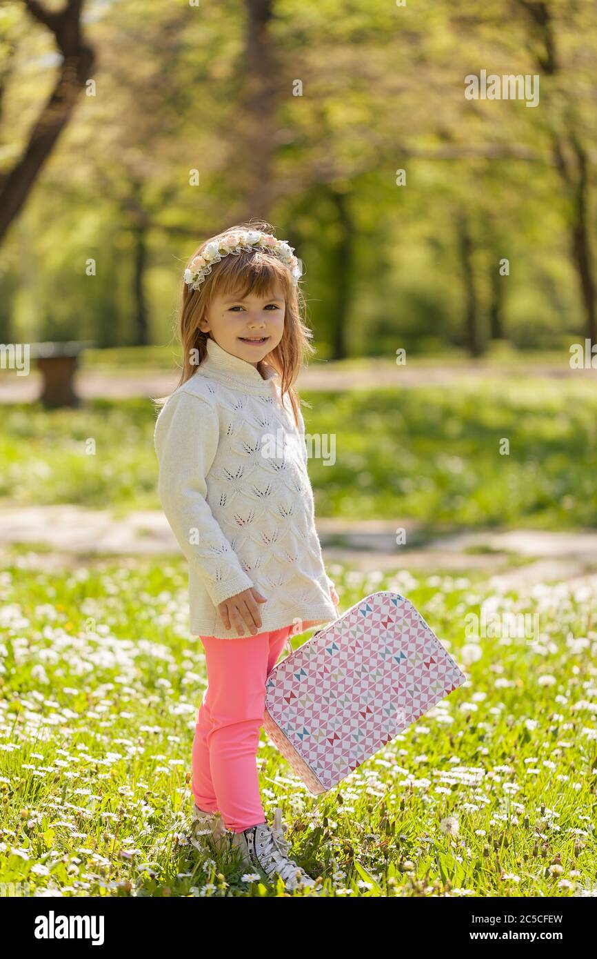a little girl poses with her suitcase Stock Photo - Alamy